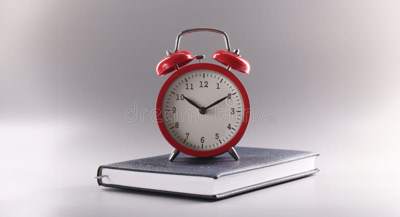 Red Retro Clock Stand on Top of Closed Book or Diary, Time To Study ...