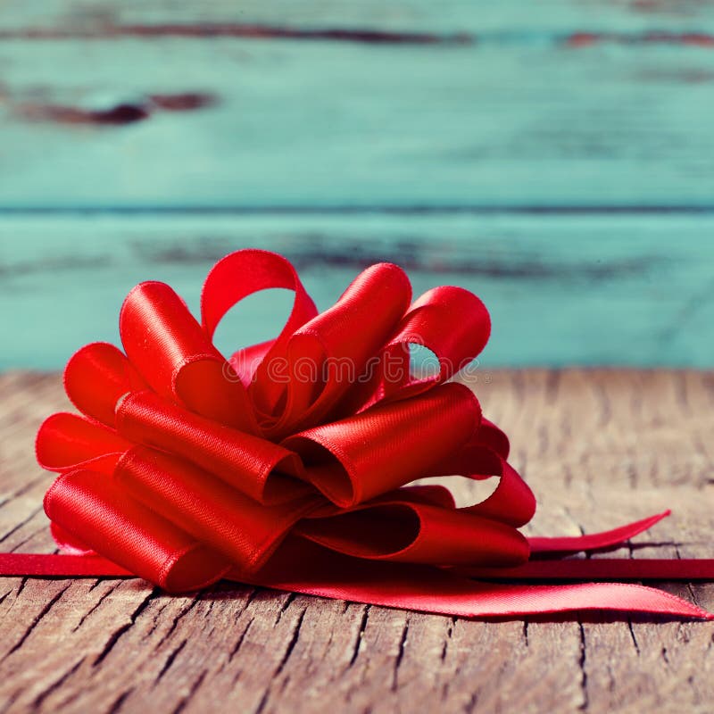Red Ribbon Bow on a Wooden Surface Stock Photo - Image of celebrate ...