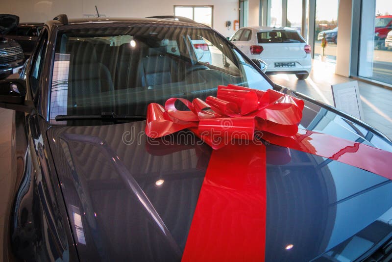 A Red Ribbon is on the Hood of a New Car Stock Photo - Image of ...