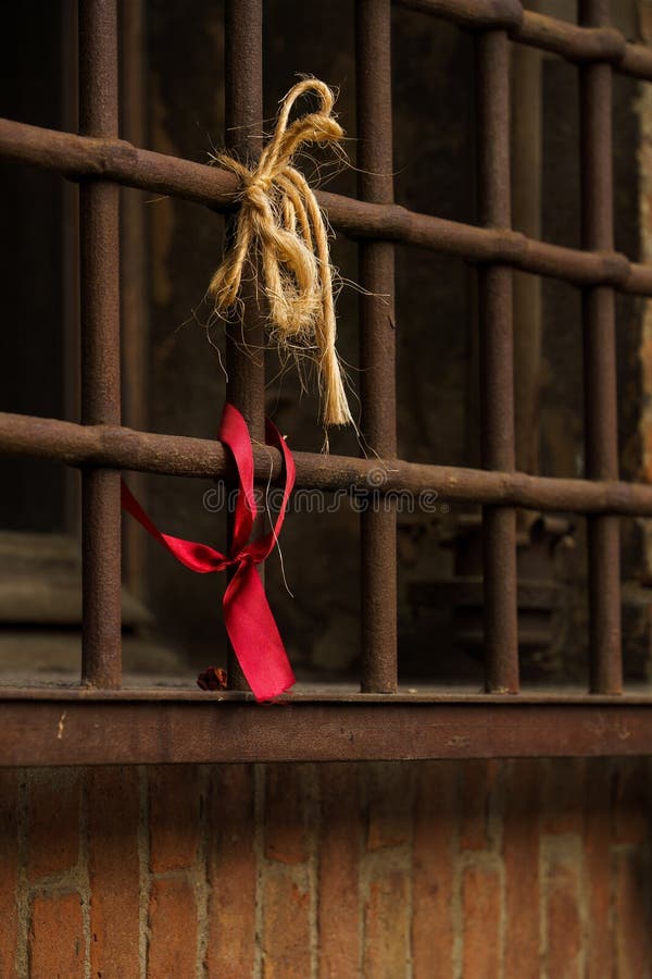 A Red Ribbon and a Piece of Rope Tied To Bars Stock Image - Image of ...