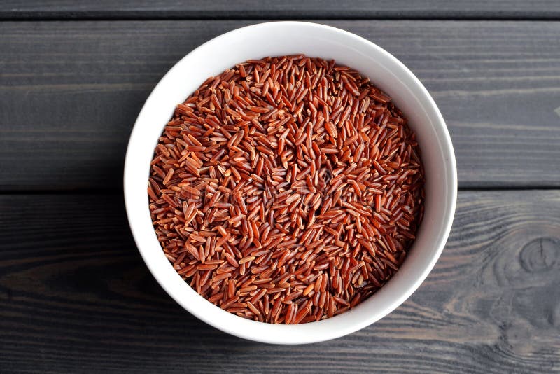 Red Rice in a Small Ceramic Bowl Against Dark Rustic Wooden Background ...