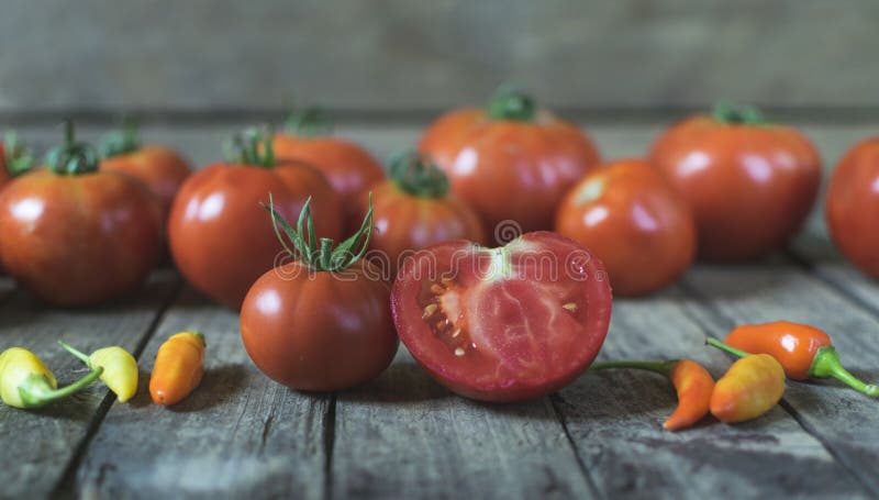 Red and Ripped Tomato and Chilli Peppers in Front of Group of To Stock ...