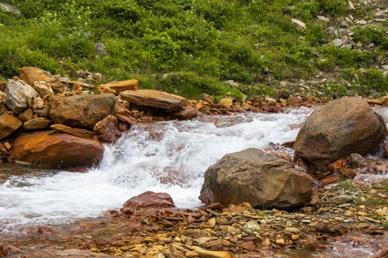 Red river rocks and water stock image. Image of tree - 323425837