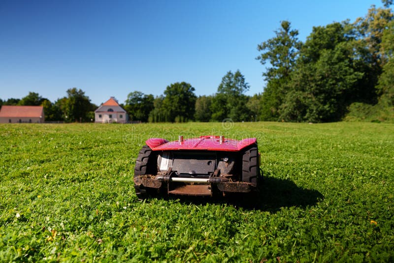Red robotic lawn mower stock photo. Image of garden - 254143592
