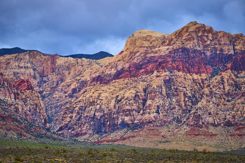 Red Rock Canyon Sandstone Cliffs with Desert Vegetation Under Cloudy ...