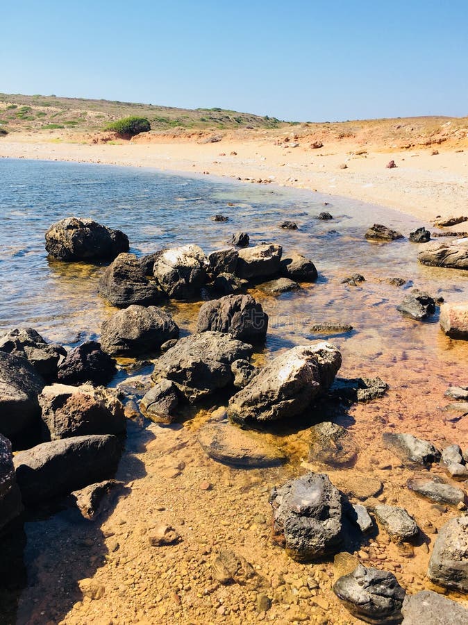 Red rock island stock photo. Image of clear, island - 125932968