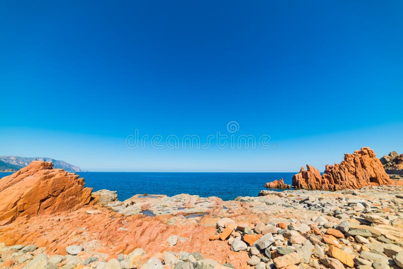 Red Rocks Beach Under a Blue Sky Stock Image - Image of shoreline ...