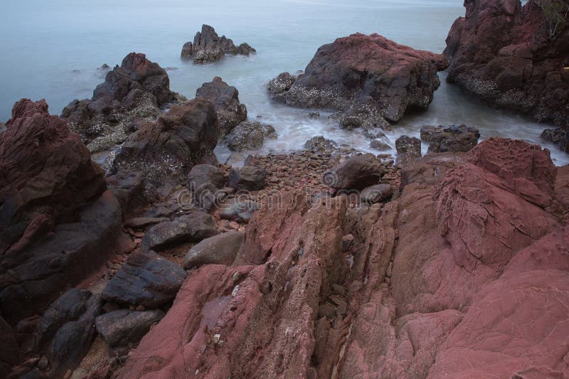 Red rocks on the coast stock image. Image of group, rock - 380865261