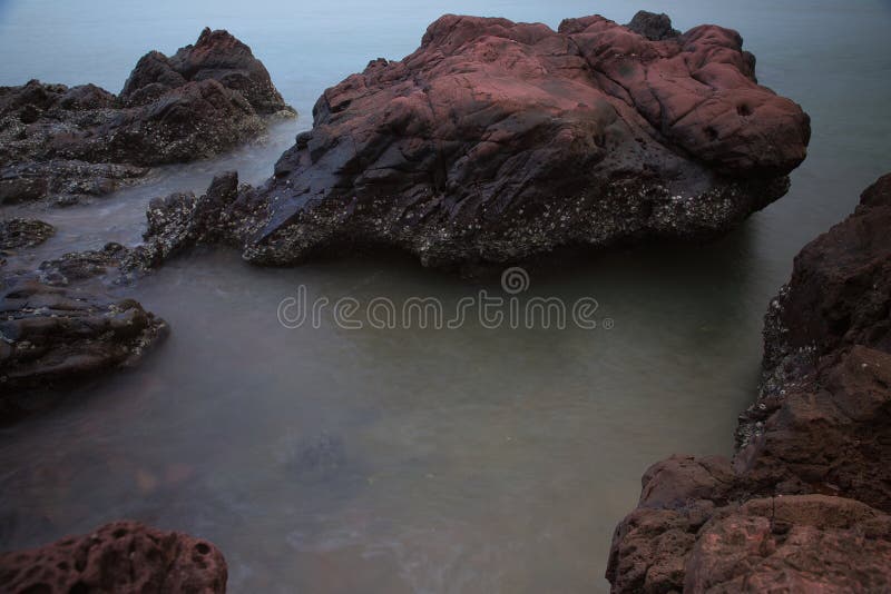Red rocks on the coast stock image. Image of orange - 380865279