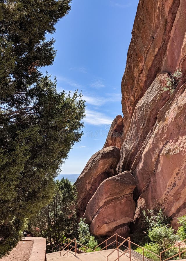 Red Rocks and Green Trees Split by the Sky Stock Photo - Image of cliff ...