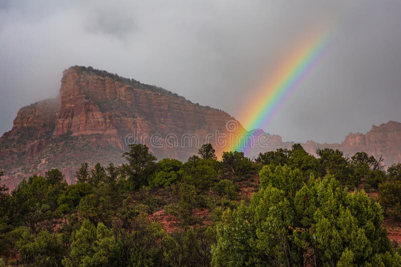 Red Rocks with Rain Storm in Background and Rainbow in Foreground Stock ...