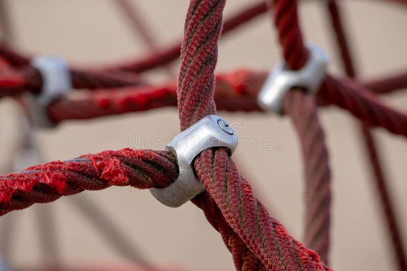 Red Rope Sections Fastened with a Metal Clamp and a Brown Sand ...