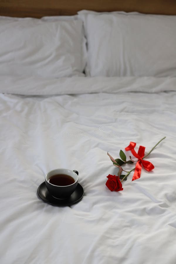 Red Rose with a Red Bow and a Black Cup of Coffee on a White Bed. Stock ...