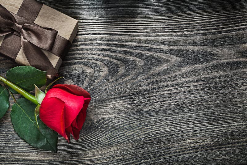 Red Rose Wrapped Gift Box on Wooden Board Holidays Concept Stock Image ...