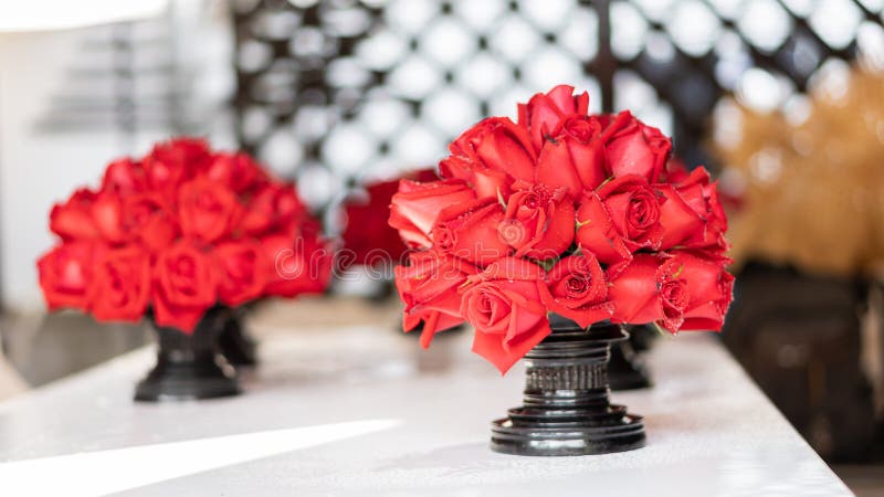 Red Roses in Black Wooden Vases on Several White Tables Stock Photo ...