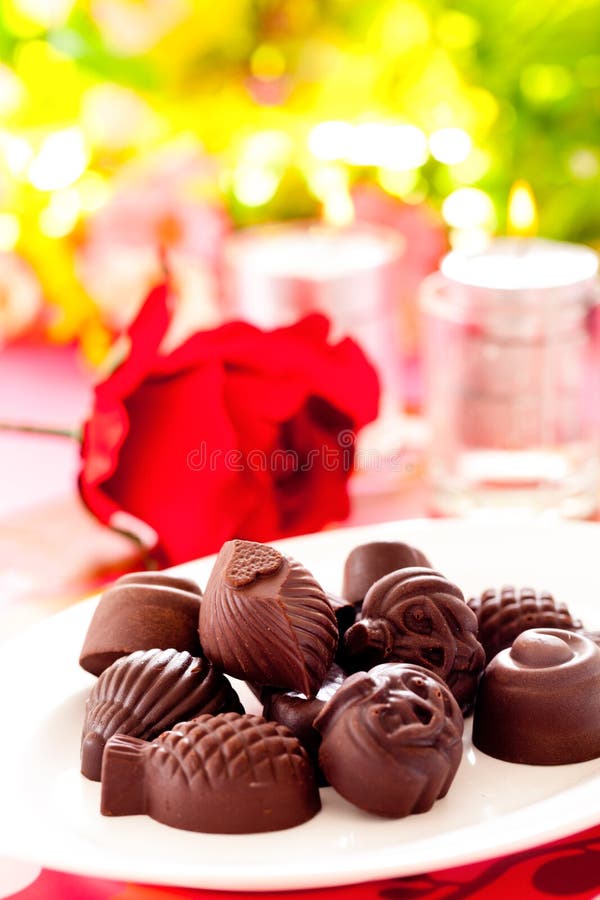 Red roses and chocolate stock image. Image of flower - 115040697