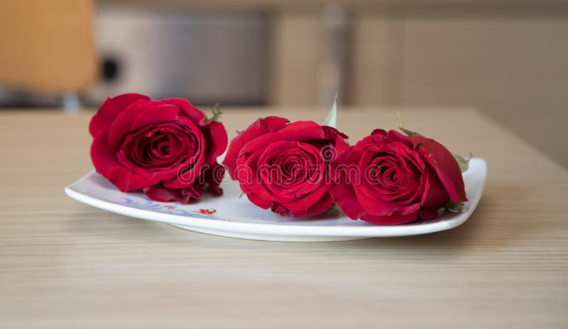 Red roses on table stock photo. Image of decoration - 134216702