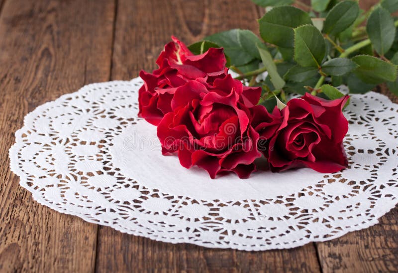 Red roses on the table stock image. Image of blossom - 141698103