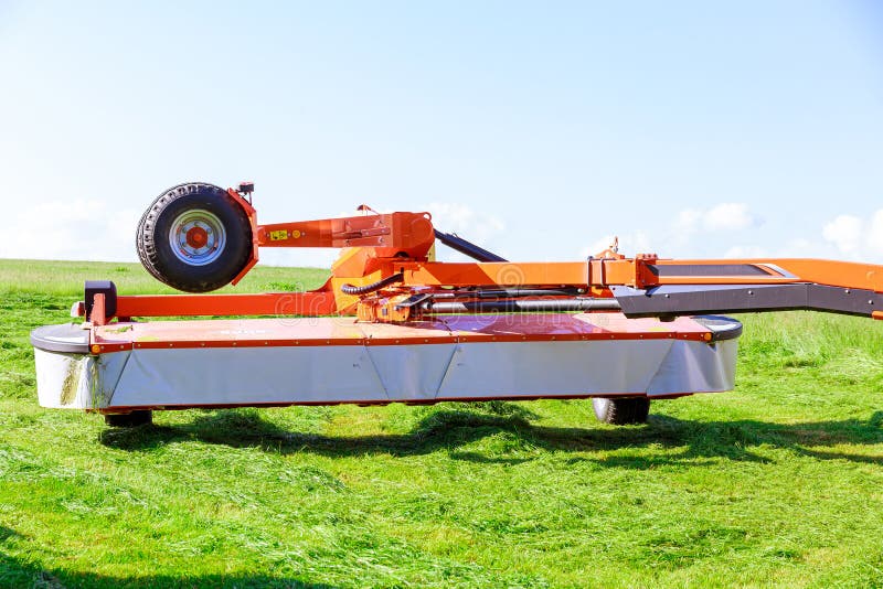 A Red Rotary Mower Cut the Grass in the Field. Clear Field Stock Image ...