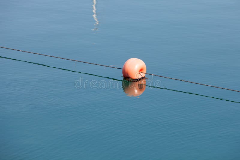 Red round buoy in the sea stock photo. Image of object - 76295314