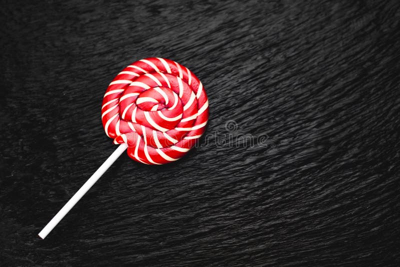 Red, Round Colored Lollipop on Black Background Stock Image - Image of ...