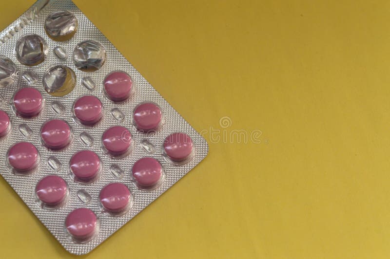 Red Round Tablets in an Open Package on a Yellow Background Stock Image ...