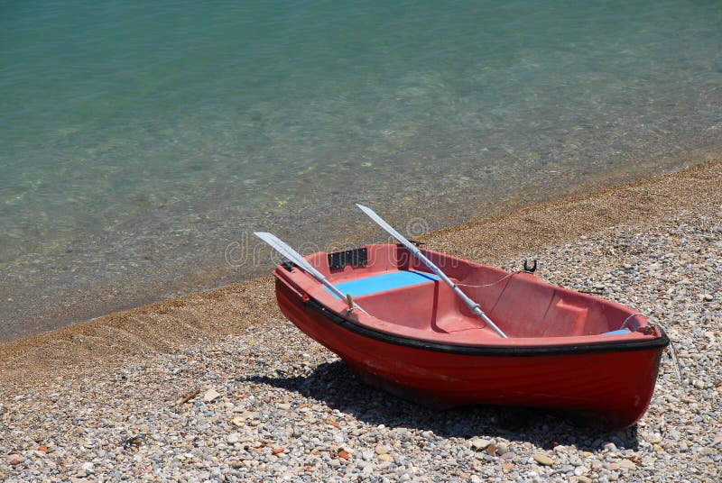 Red rowboat on beach stock image. Image of mediterranean - 2694821