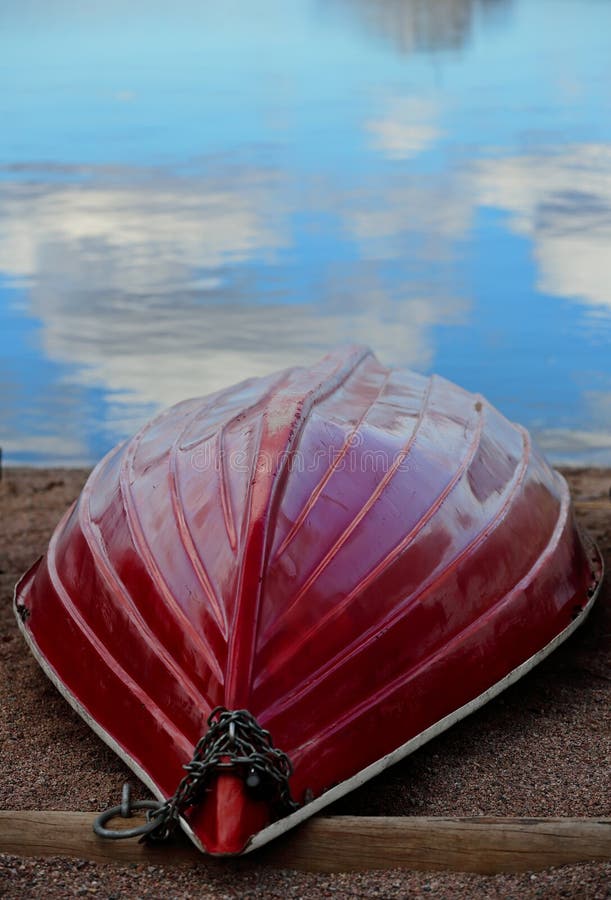 Red Rowboat on the Shore with Chains Stock Photo - Image of waiting ...