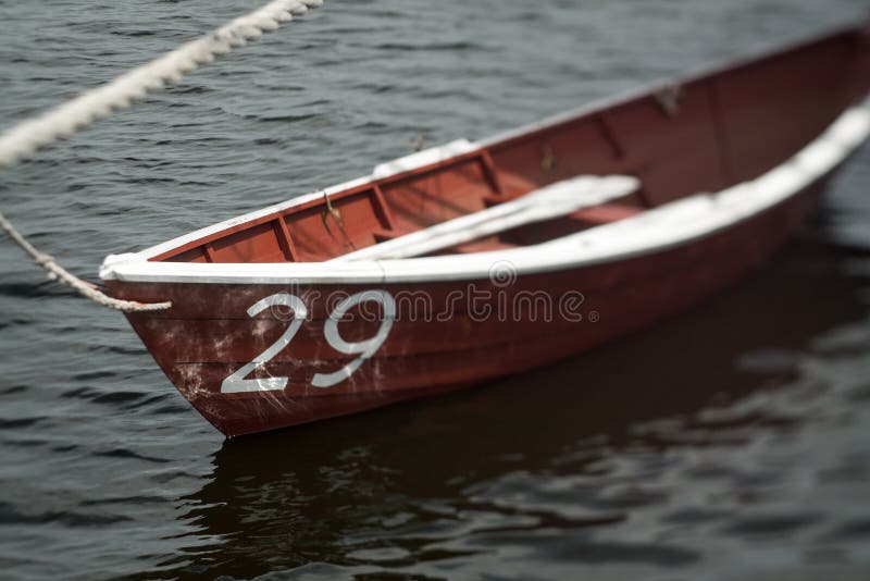 Red Rowboat in the Water stock photo. Image of rowboat - 224261200
