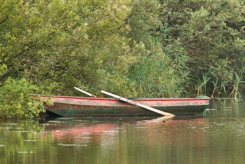 Red rowing boat on lake stock photo. Image of lake, reflection - 27340644
