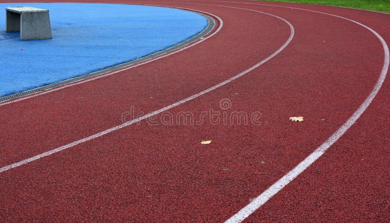 Red Sports Running Track Curve with Blue Sports Field and Bench in Left ...