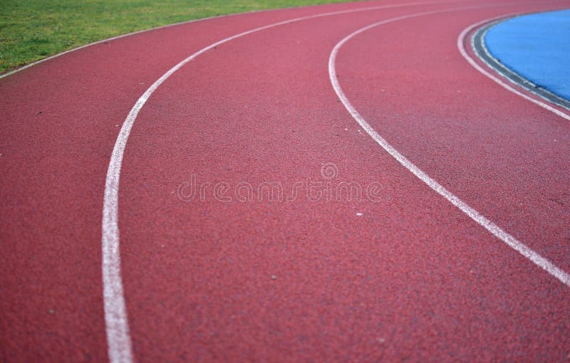 Red Running Track Curve with Green Grass in Left Side Stock Image ...