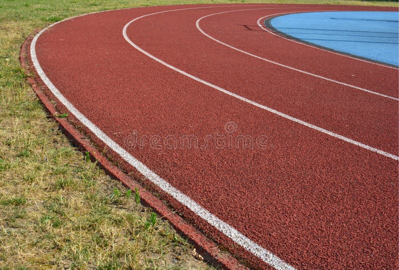 Red Running Track with Grass in Left Side and Blue Sports Field Stock ...