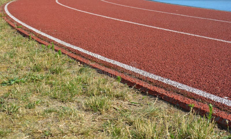 Red Running Track with Grass in Left Side and Blue Sports Field Stock ...