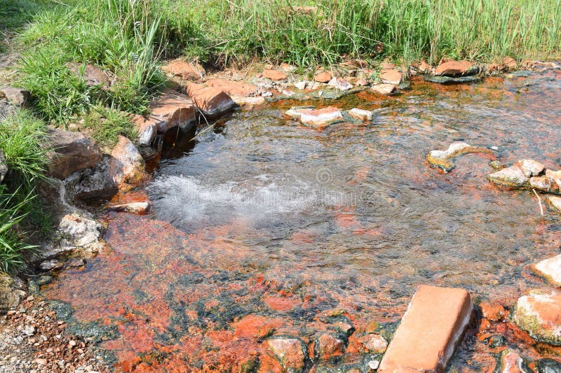 A Red Rusty Water Spring with Green Grass Around Stock Photo - Image of ...