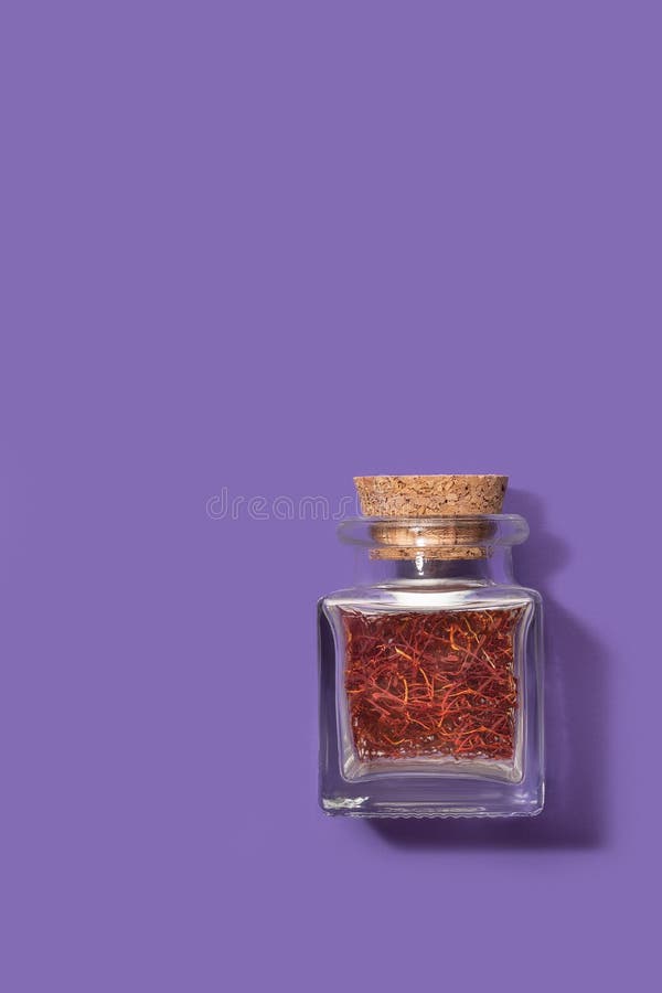 Red Saffron Spice on a Purple Background. Aromatic Saffron Spice Bottle ...