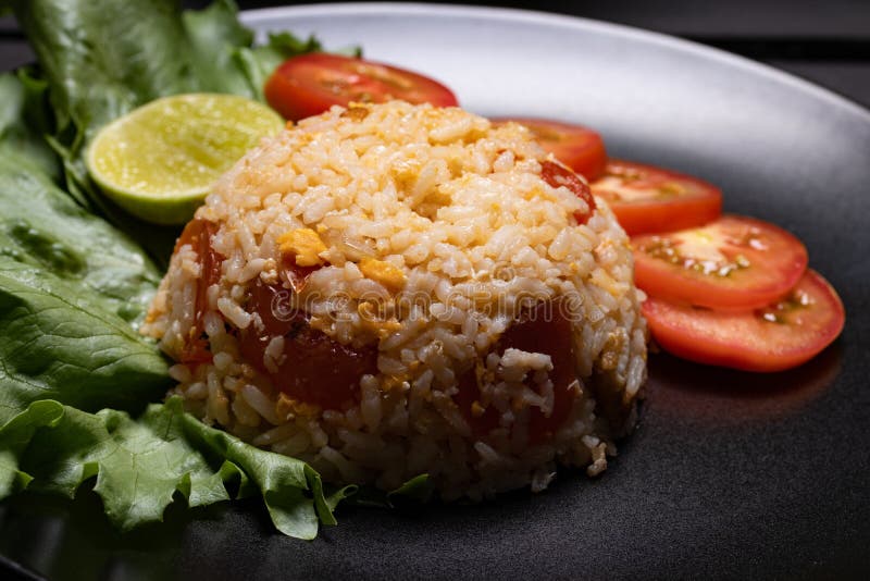 Red Salted Egg Fried Rice with Vegetables in Black Plate Stock Image ...