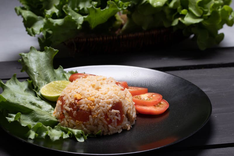 Red Salted Egg Fried Rice with Vegetables in Black Plate Stock Image ...