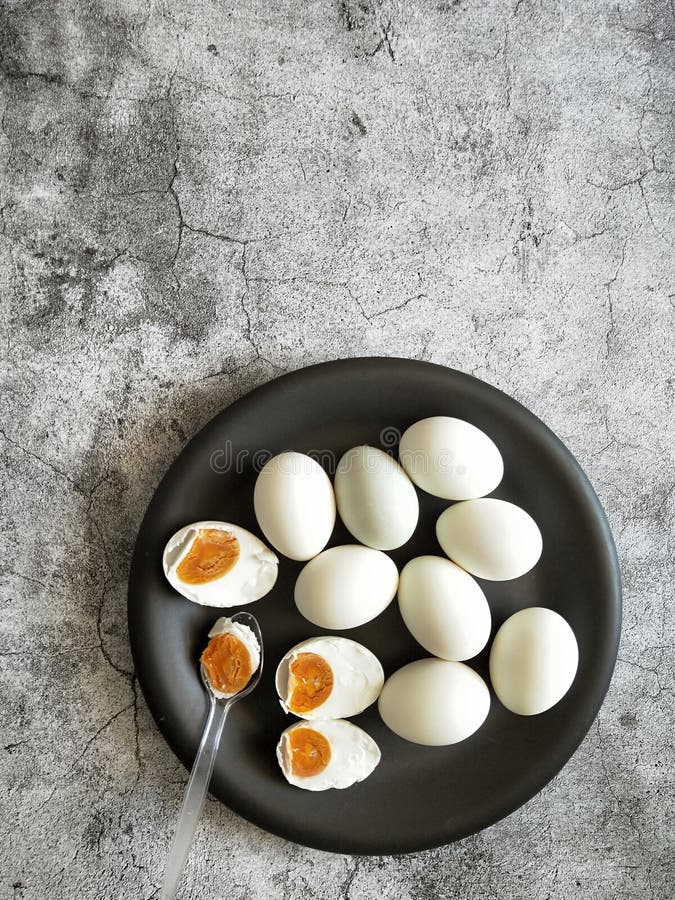 Red Salted White Eggs on a Black Plate Stock Photo - Image of worker ...