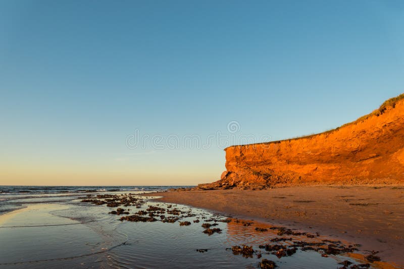 Red Sand Shores of Prince Edward Island Stock Photo - Image of house ...