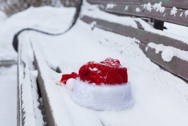 Red Santa Claus Hat on Bench with Snow Stock Photo - Image of furry ...