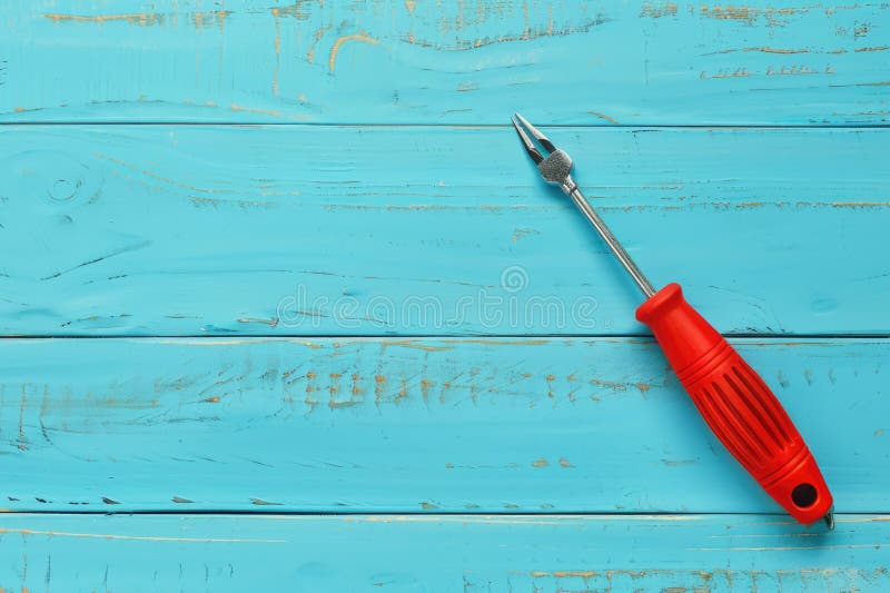 A Red Screwdriver Placed on a Blue Wooden Table. Suitable for DIY and ...