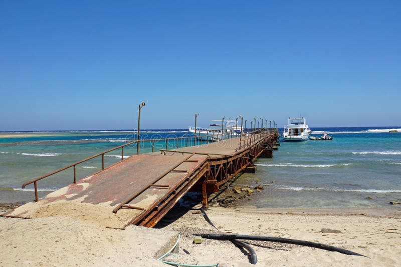 Old Weathered Jetty Posts Standing in Row on Beach Casting Shadow on ...