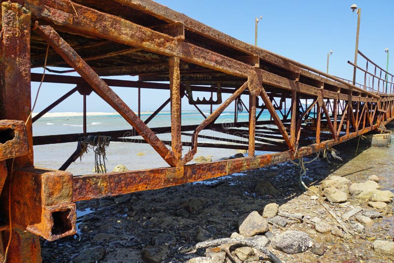 Old Weathered Jetty Posts Standing in Row on Beach Casting Shadow on ...
