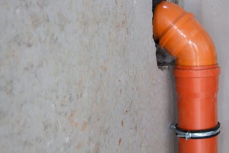 The Red Sewer Pipe or Sewer Pipe on the Concrete Wall is Fixed with ...