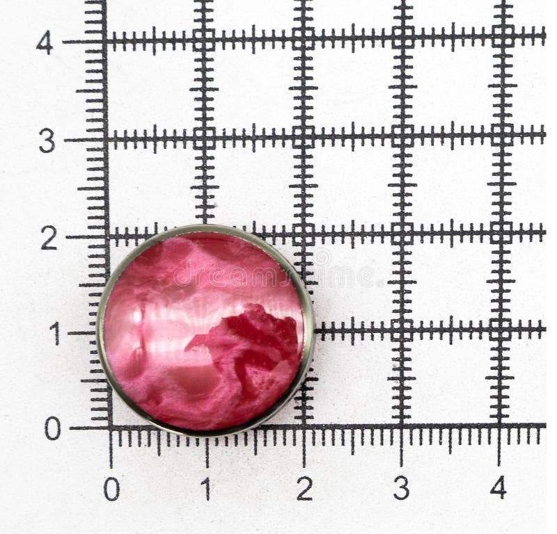Red Sewing Button with a Beautiful Pattern on a Square Measuring Ruler ...