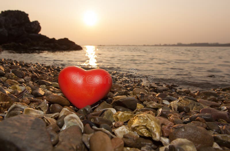 Red shape heart on rock stock photo. Image of beach, holidays - 49360870