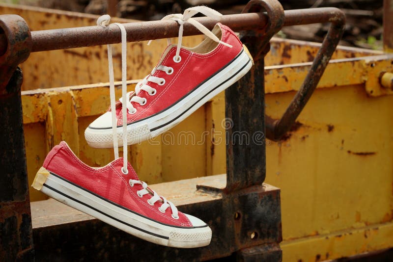 Red Shoes Hanging on a Yellow Steel. Stock Image - Image of standing ...