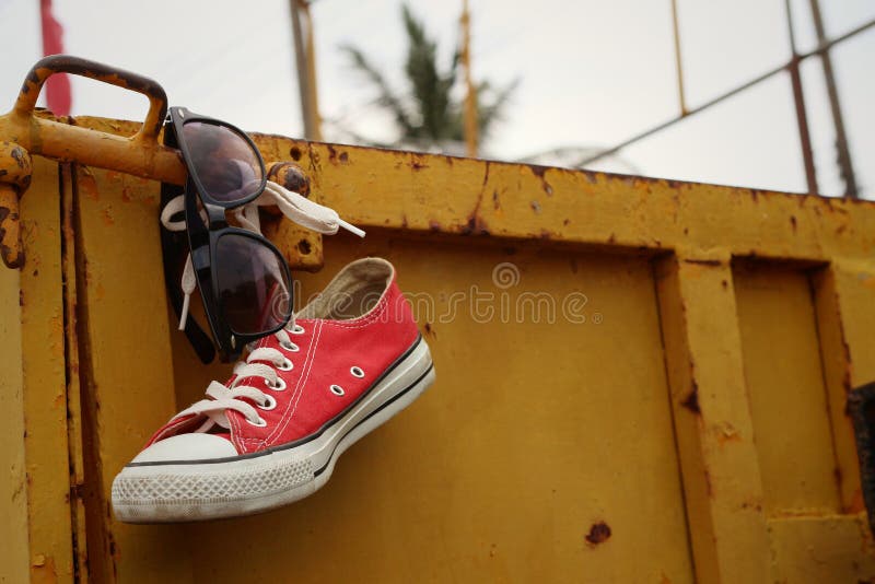 Red Shoes with Sunglasses Hanging on Steel. Stock Photo - Image of ...