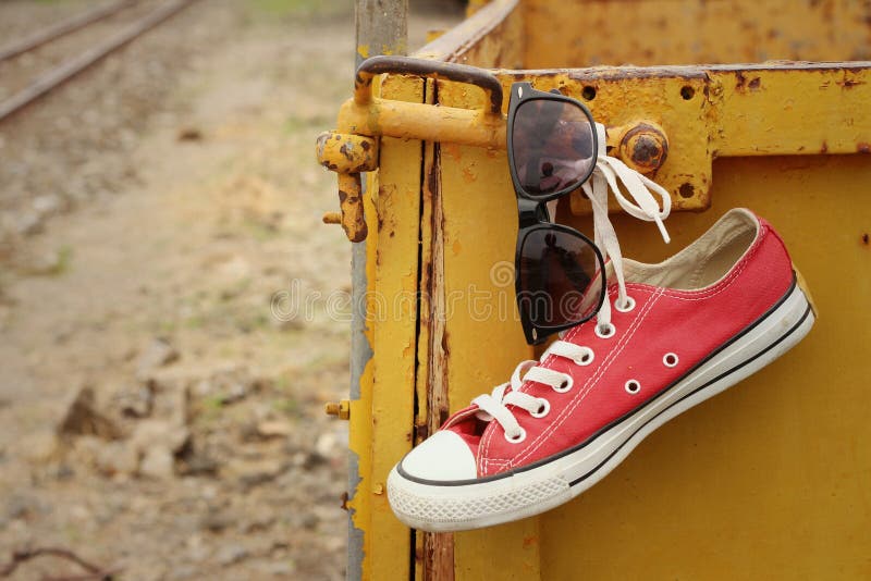 Red Shoes with Sunglasses Hanging on Steel. Stock Image - Image of ...